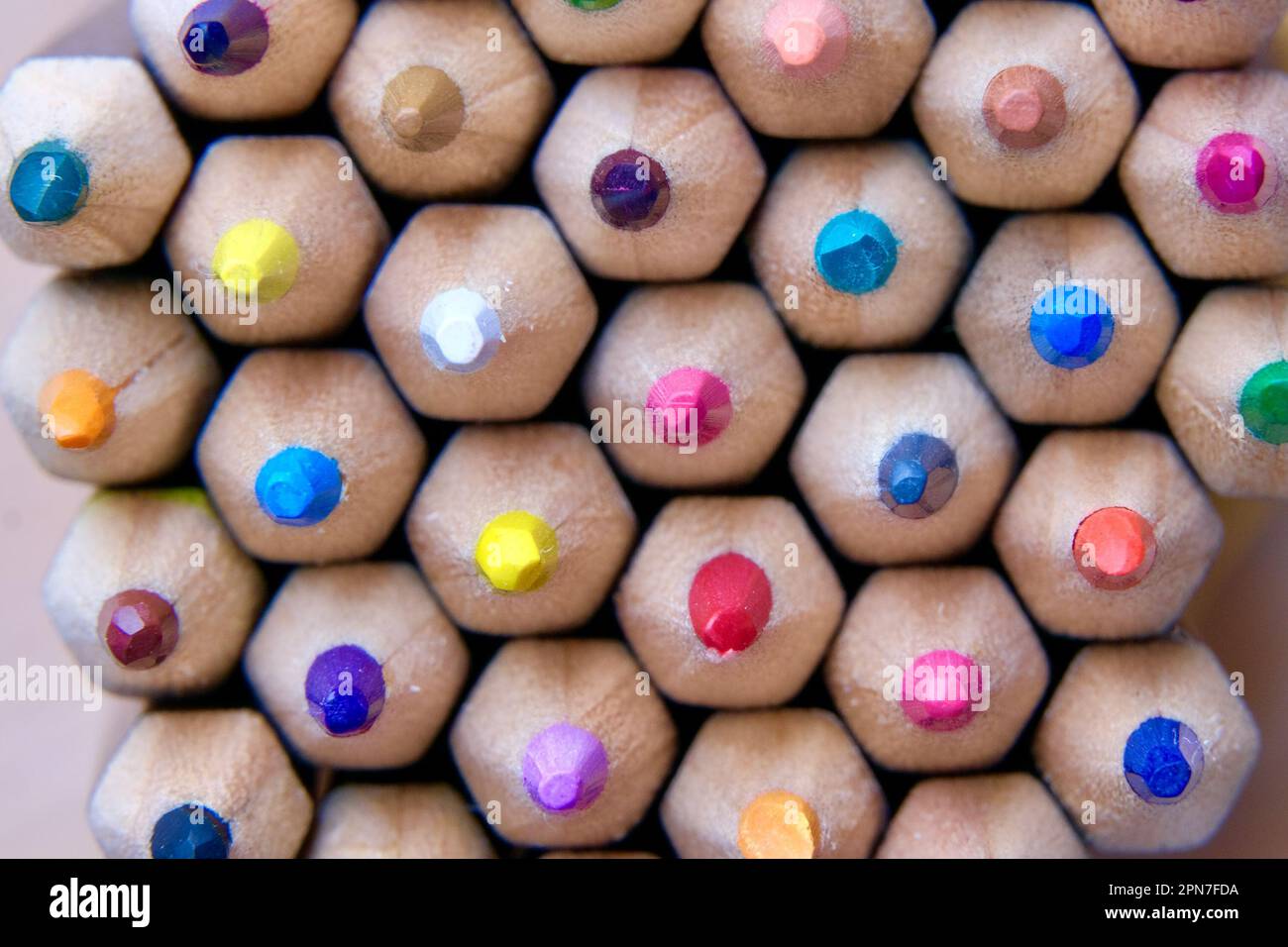 An array of assorted colored pencils arranged in a tower-like formation ...