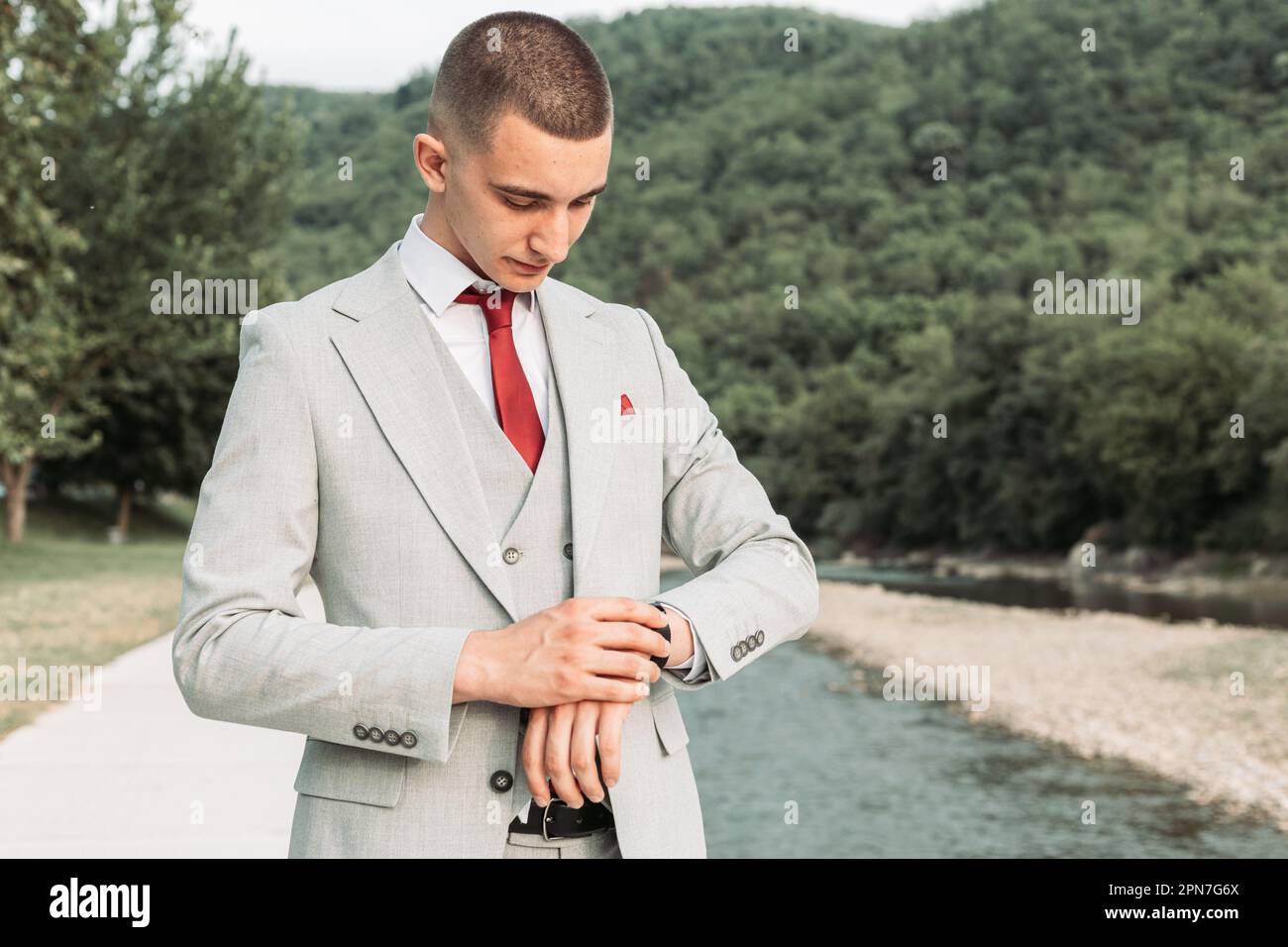 Young teenage boy looking at his watch. Ready for a prom night Stock ...