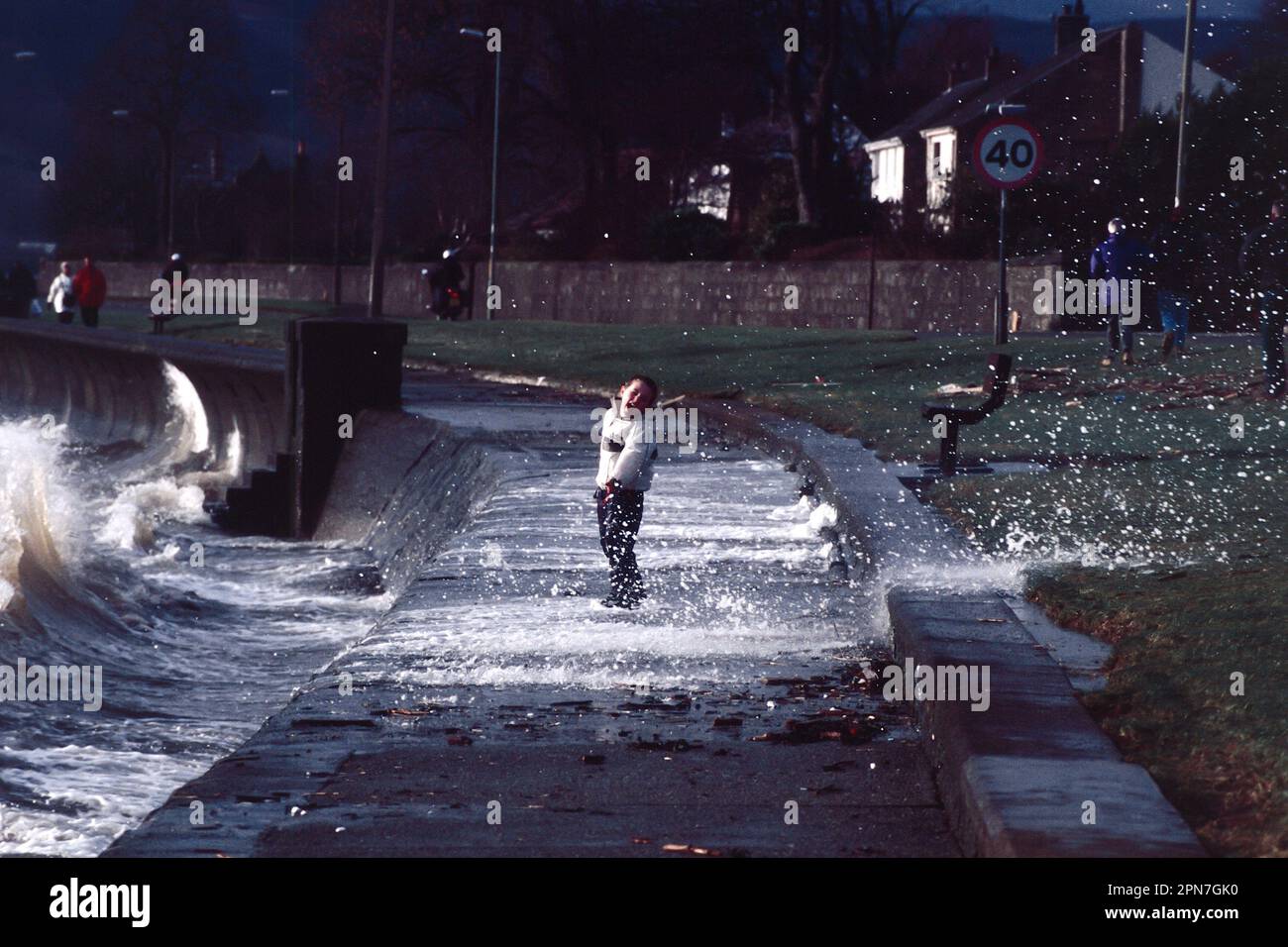Boy caught by the waves during a storm, Helensburgh, Scotland Stock ...