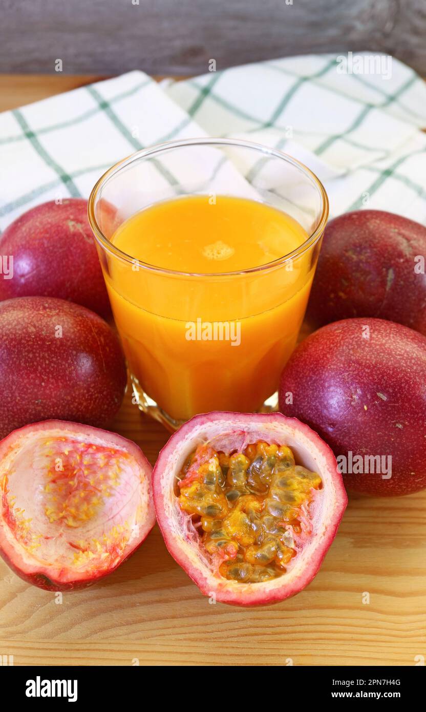Glass of Fresh Passion Fruit Juice with Heap of Cut and Whole Fruits ...