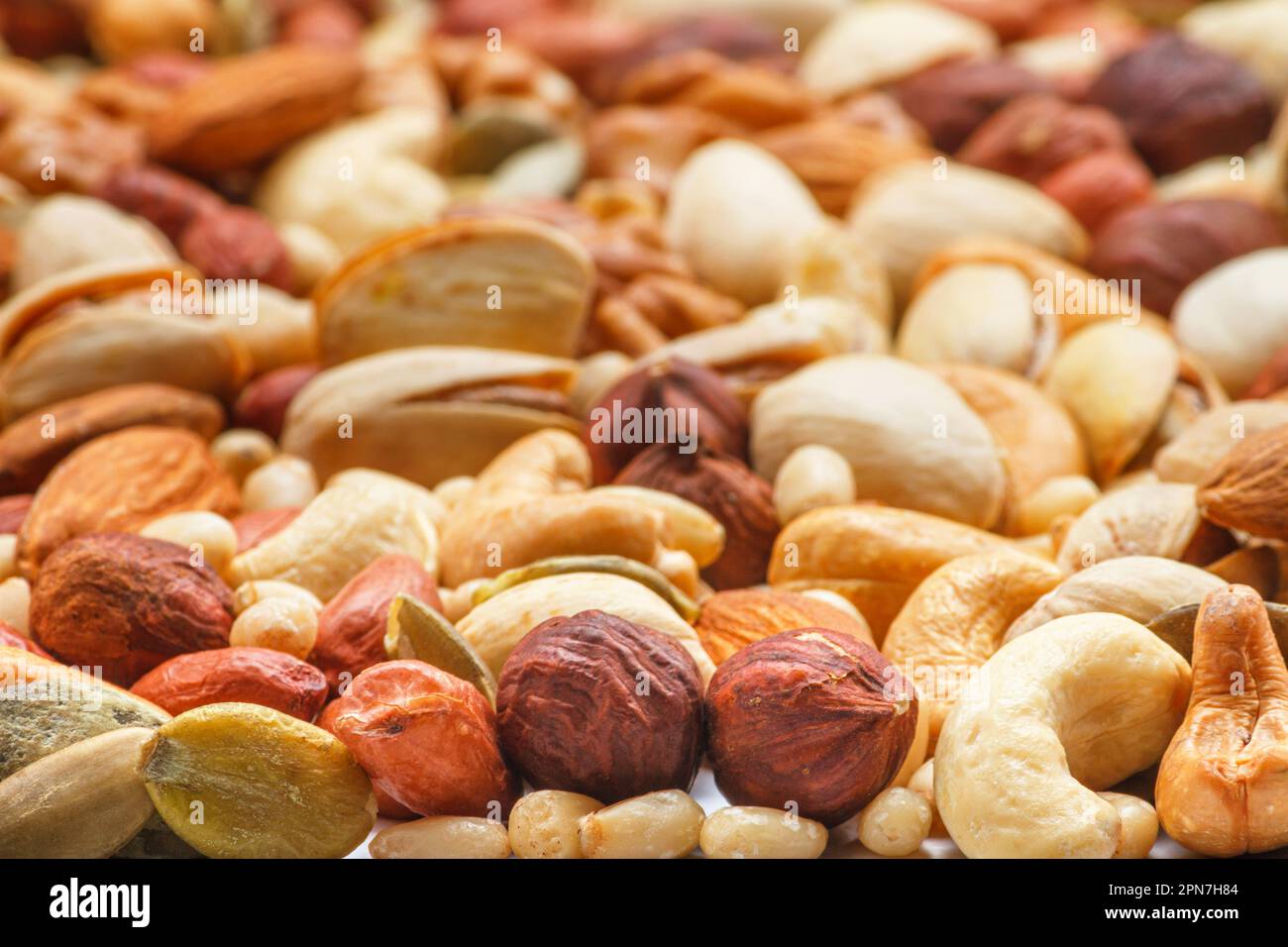 Different types of nuts and seeds, photo with selective focus. Peeled ...