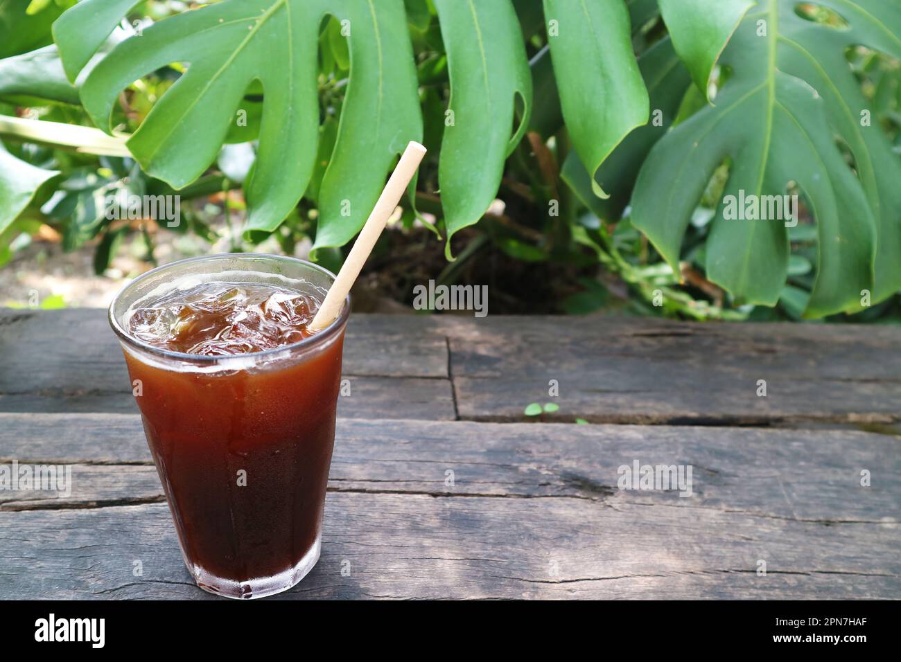 Glass of Chilled Iced Coffee Isolated on Garden Wooden Table Stock ...