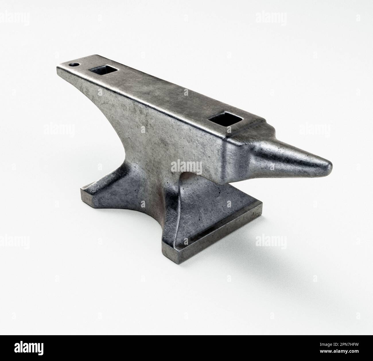 A heavy iron blacksmiths anvil on an isolated white studio background ...