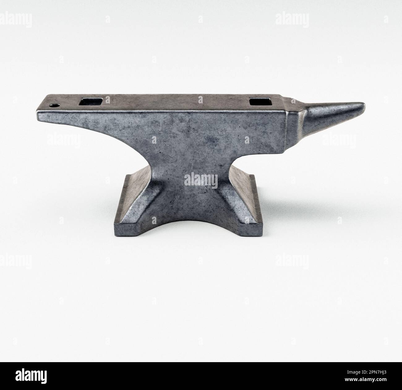 A heavy iron blacksmiths anvil on an isolated white studio background ...