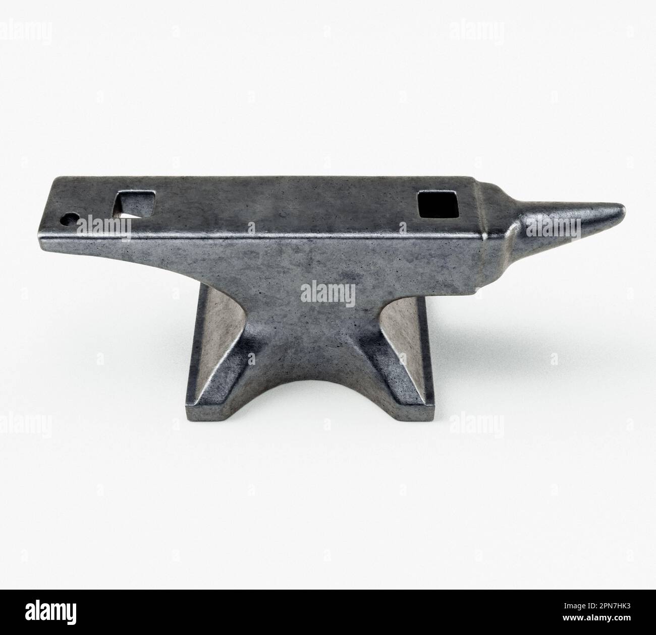 A heavy iron blacksmiths anvil on an isolated white studio background ...