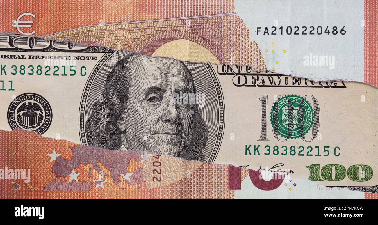 100 dollar banknote through torn Euro banknote for design purpose Stock ...