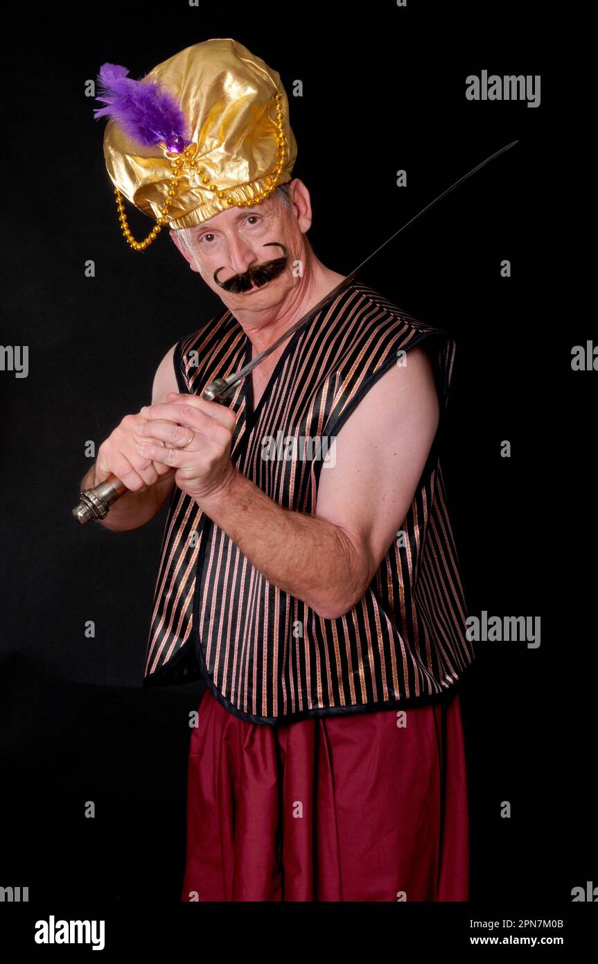 An elder sultan or sheik with a sword isolated over black Stock Photo ...