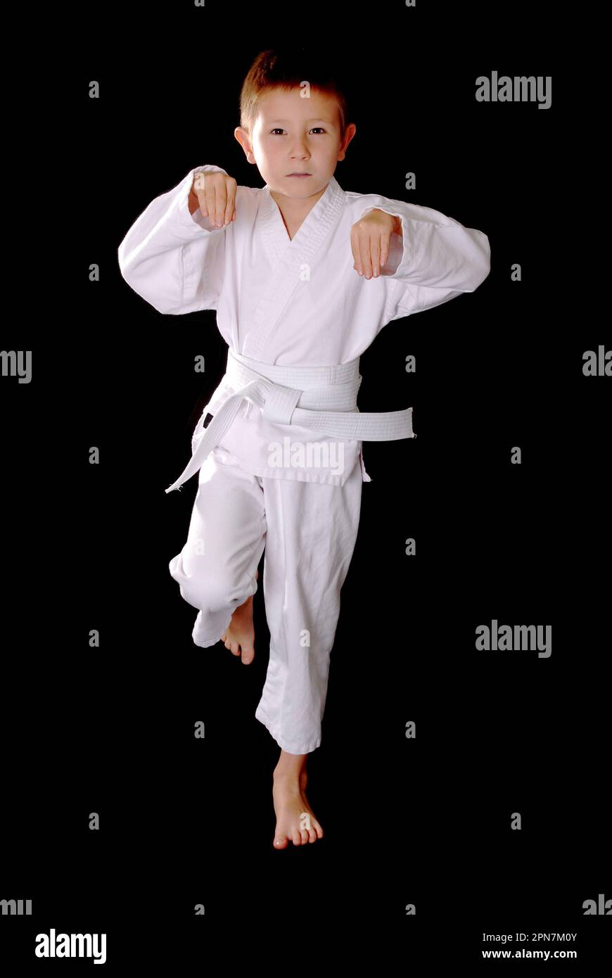 Young boy in karate outfit making fighting movement Stock Photo - Alamy