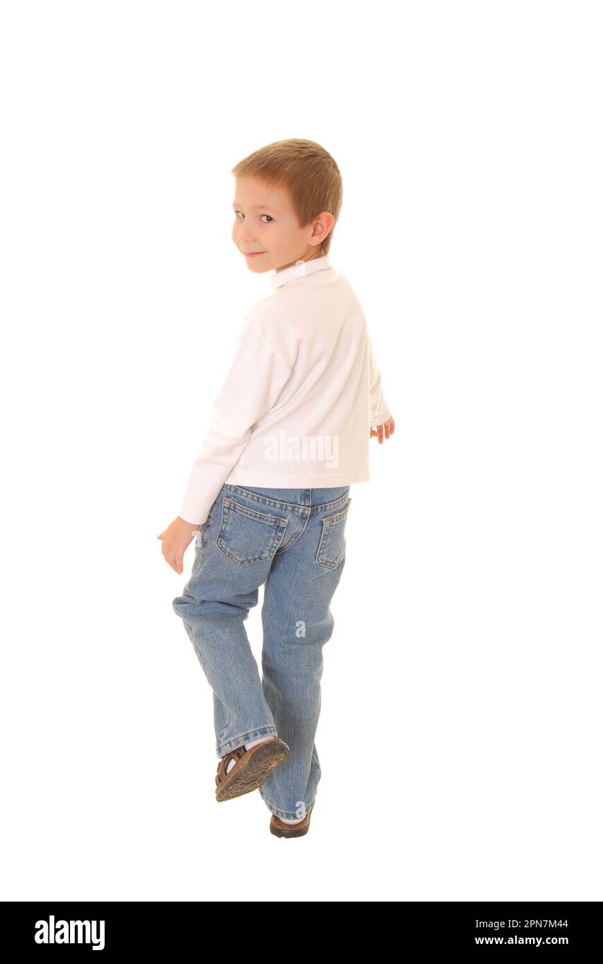 Portrait of a young boy walking away Stock Photo - Alamy