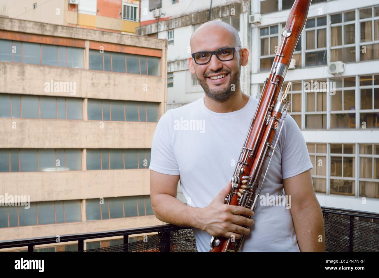 Waist-up portrait of young orchestra musician Venezuelan Latin man with ...