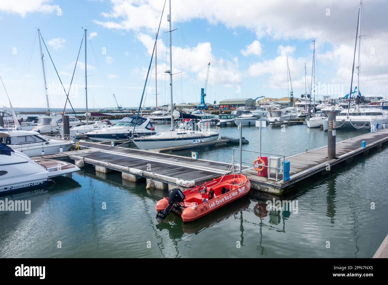 Boats moored to pontoons in Poole Harbour in Dorset, UK Stock Photo - Alamy