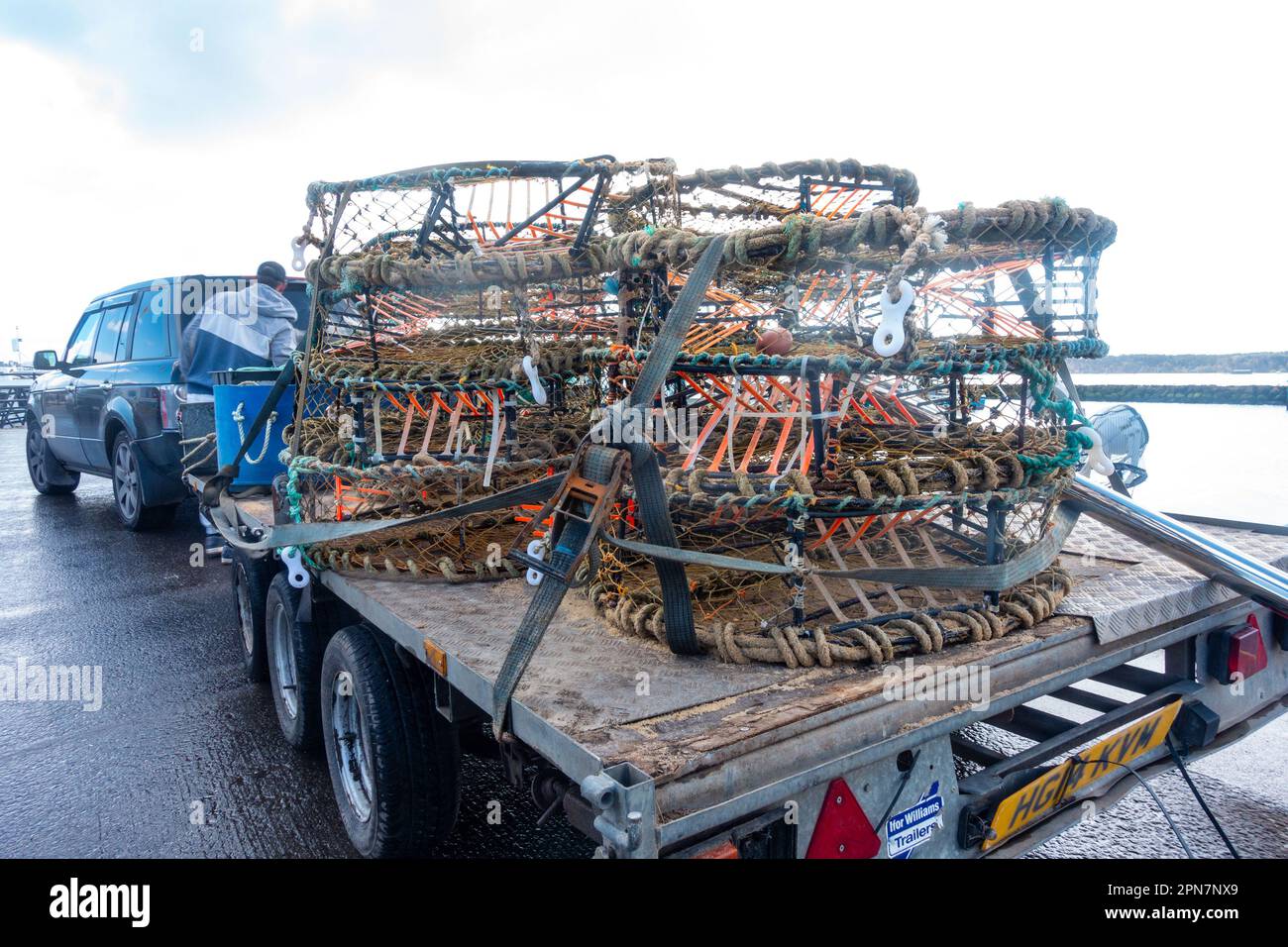 Crab pots loaded on the back of a car trailer on the quayside at Poole ...