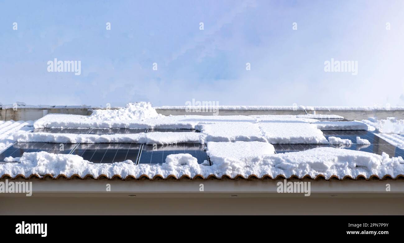 Solar Autonomous Photovoltaic Panel half covered with fluffy white snow ...