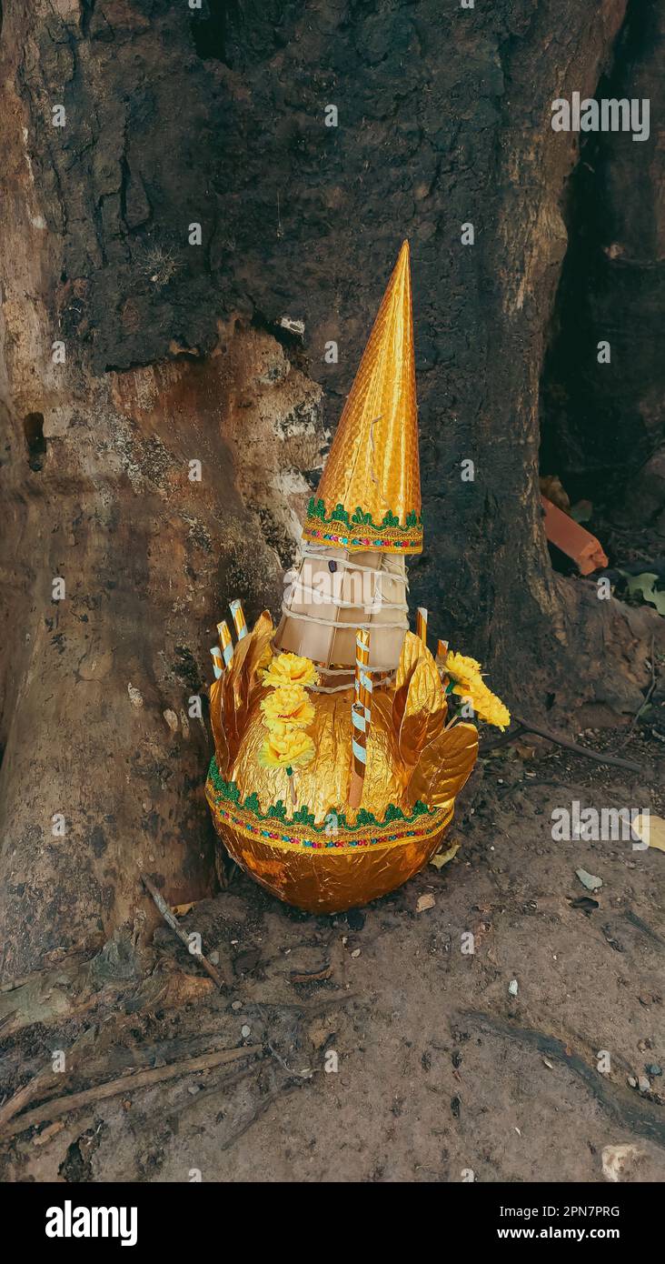 A vertical shot of a golden torma, a ceremonial sacred ritual offering ...