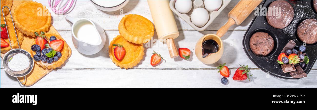 Summer baking background with baked pastry - berry cakes, muffins, mini ...