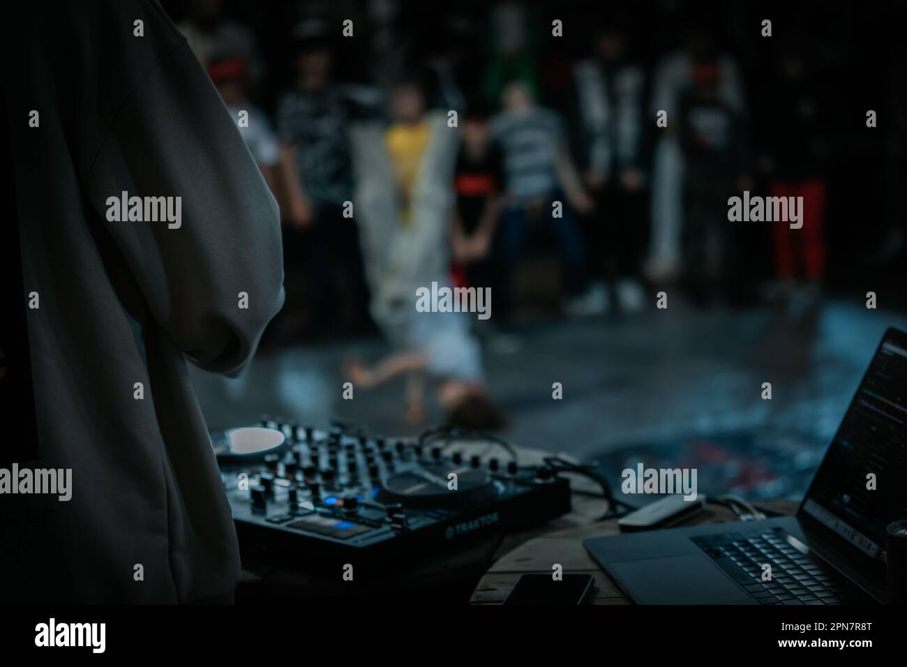 A group of people on a dancing arena during a competition seen through ...