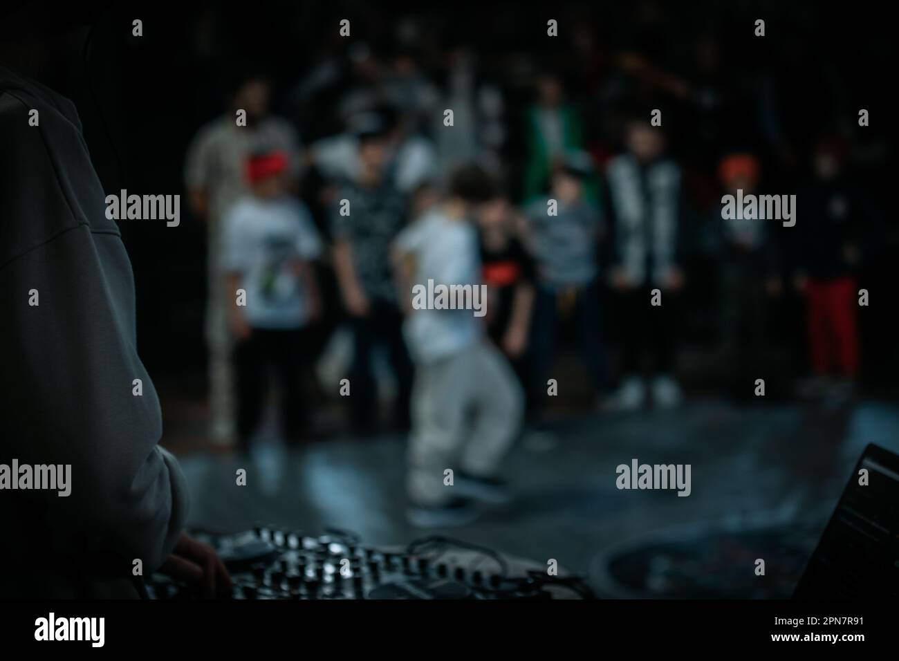A group of people on a dancing arena during a competition seen through ...