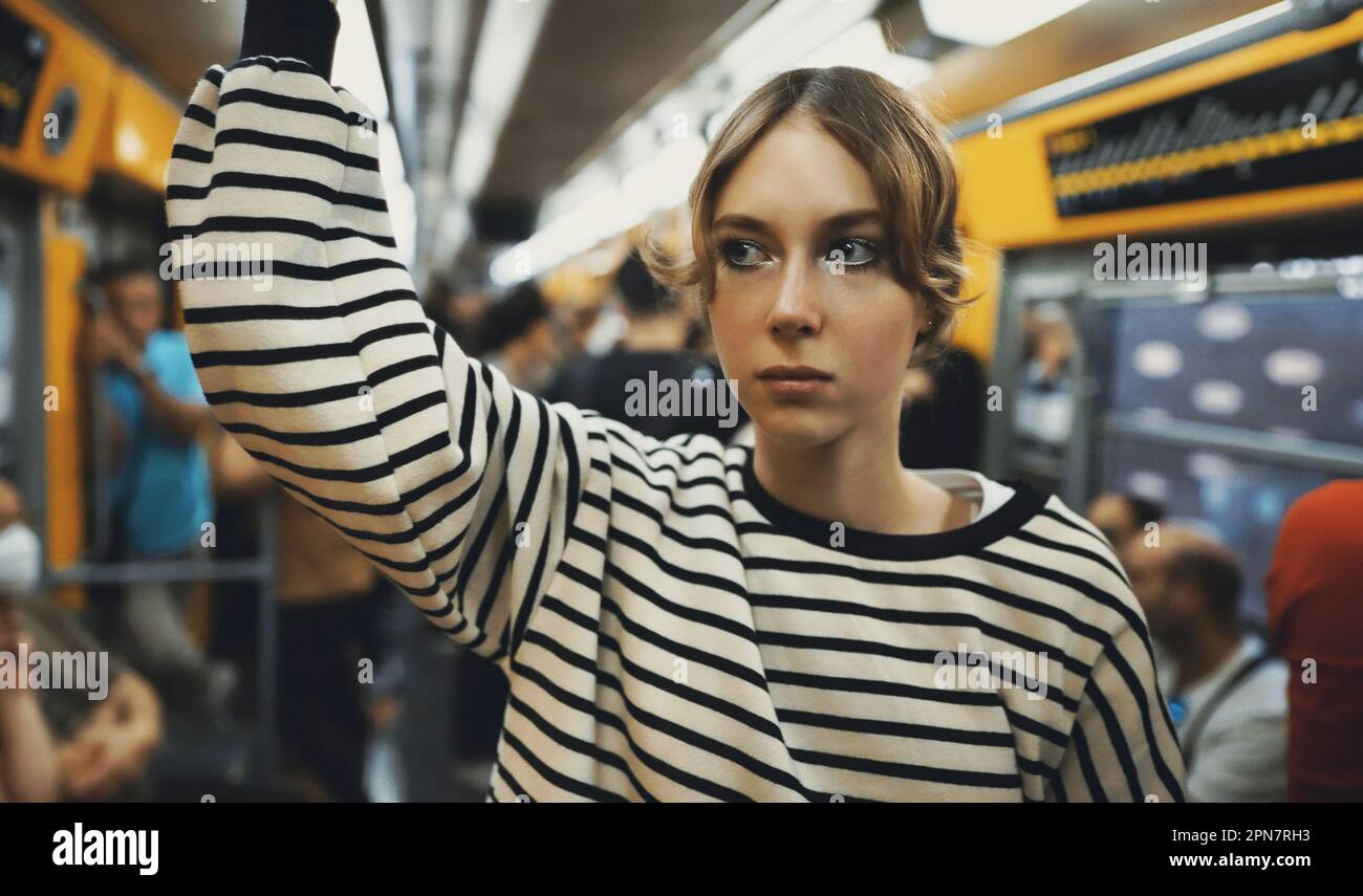 Teenage girl rides in a subway train Stock Photo - Alamy