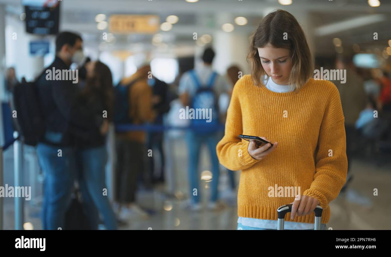 Teenage girl is waiting for her flight at the airport Stock Photo - Alamy