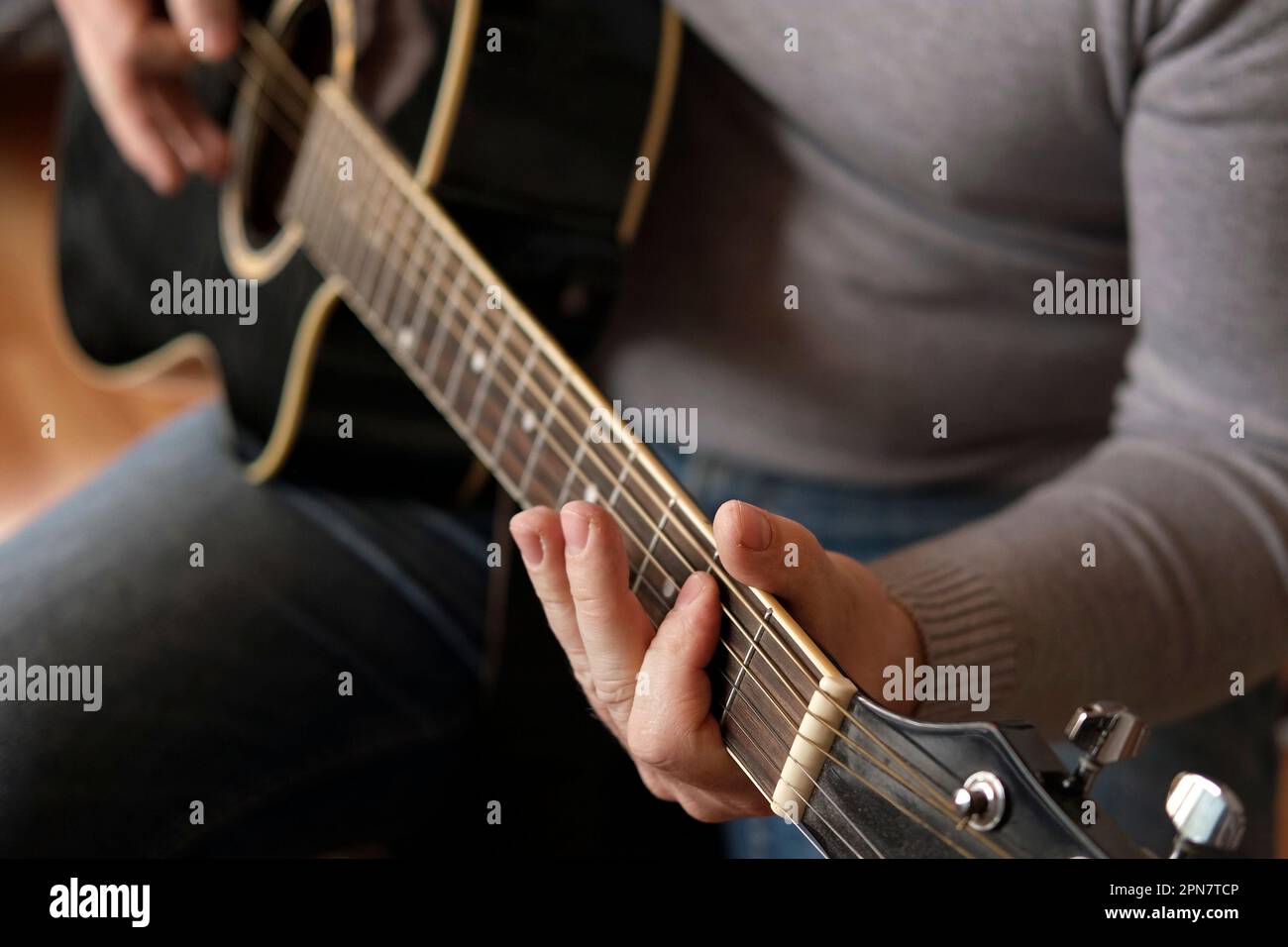 Playing the guitar. Strumming acoustic guitar. Musician plays music ...