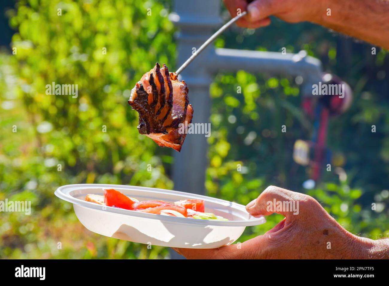 Garden bacon roasting at summer Stock Photo - Alamy