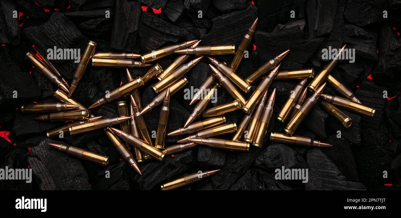 Cartridges for automatic carbine caliber .223 on charcoal. Ammunition ...