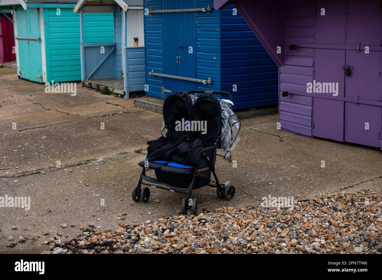 Double buggy, double pushchair left by Beach hut on the Southcoast ...