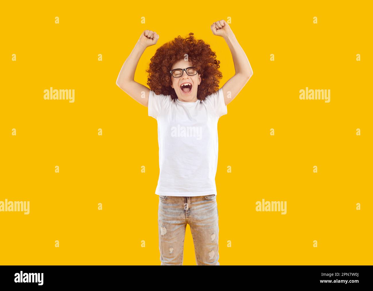 Happy funny little child standing on color background, raising hands up ...