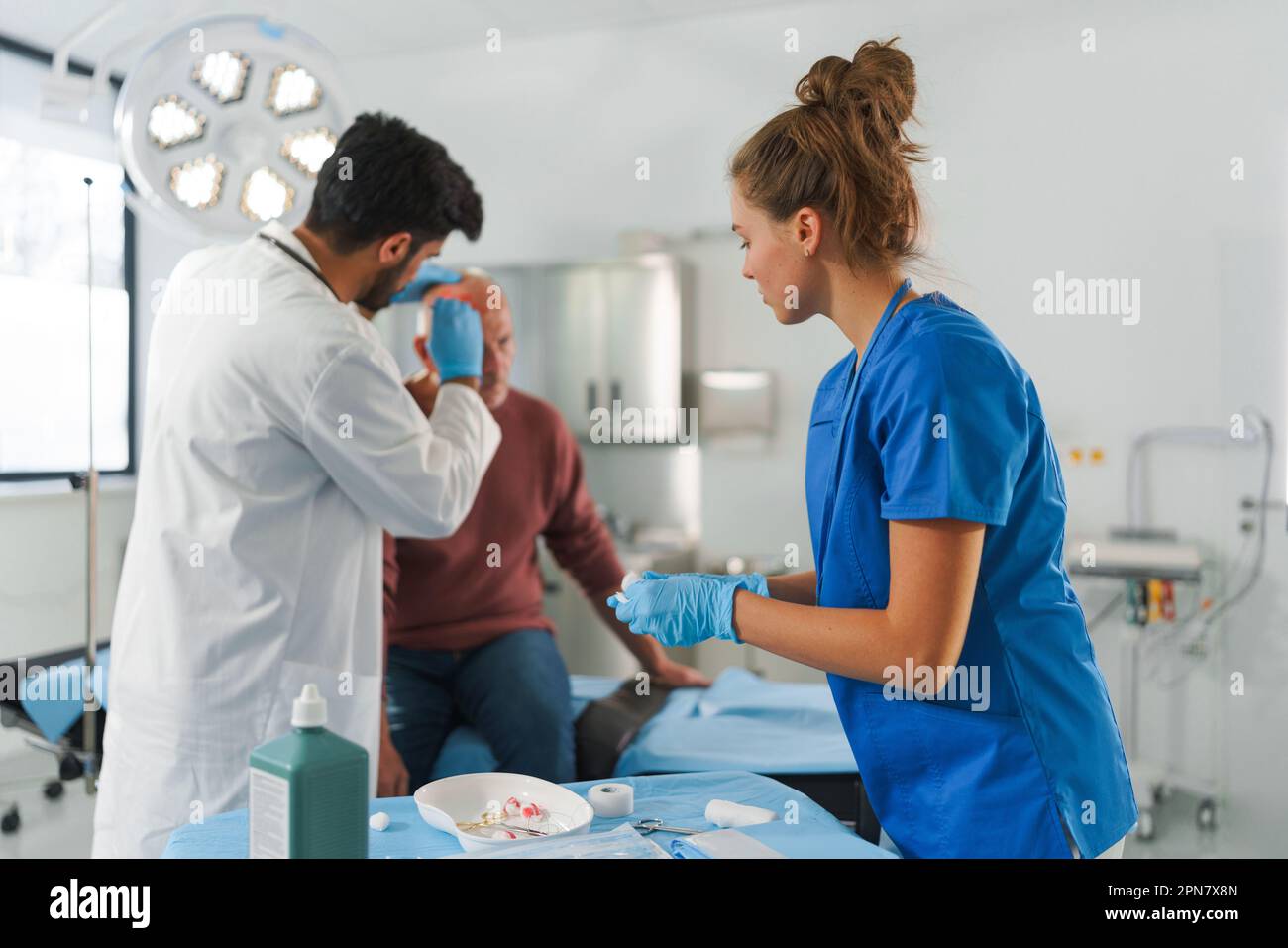Doctor treating elderly patient hi-res stock photography and images - Alamy