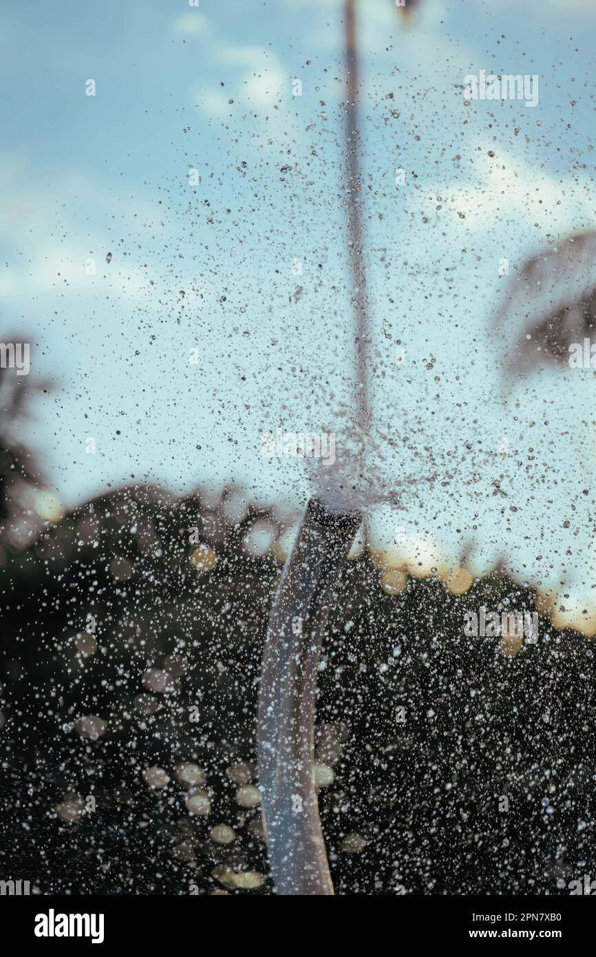 A stream of water splashing from a pipe, creating a dramatic effect ...