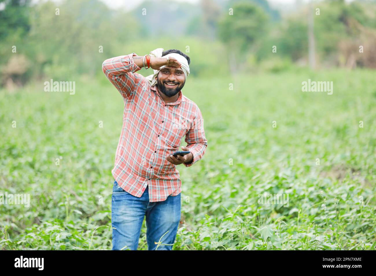 Happy Indian farmer, young farmer smiling in farm Stock Photo - Alamy