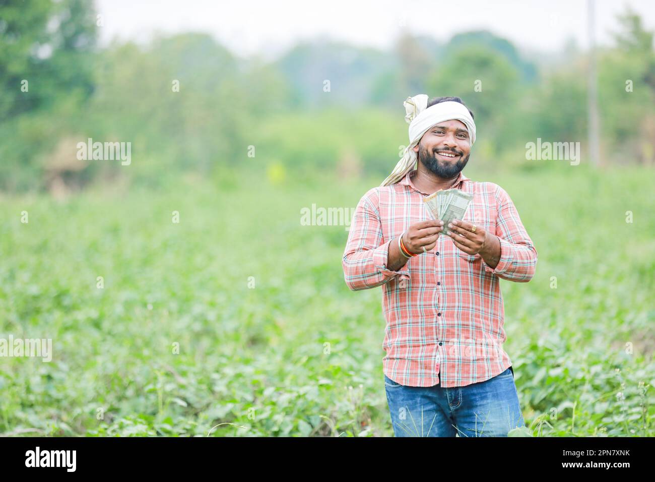 Happy Indian farmer, young farmer smiling in farm Stock Photo - Alamy