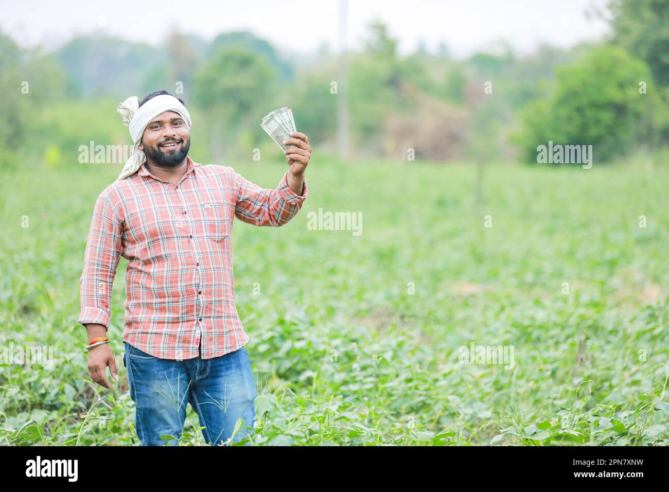 Happy Indian farmer, young farmer smiling in farm Stock Photo - Alamy