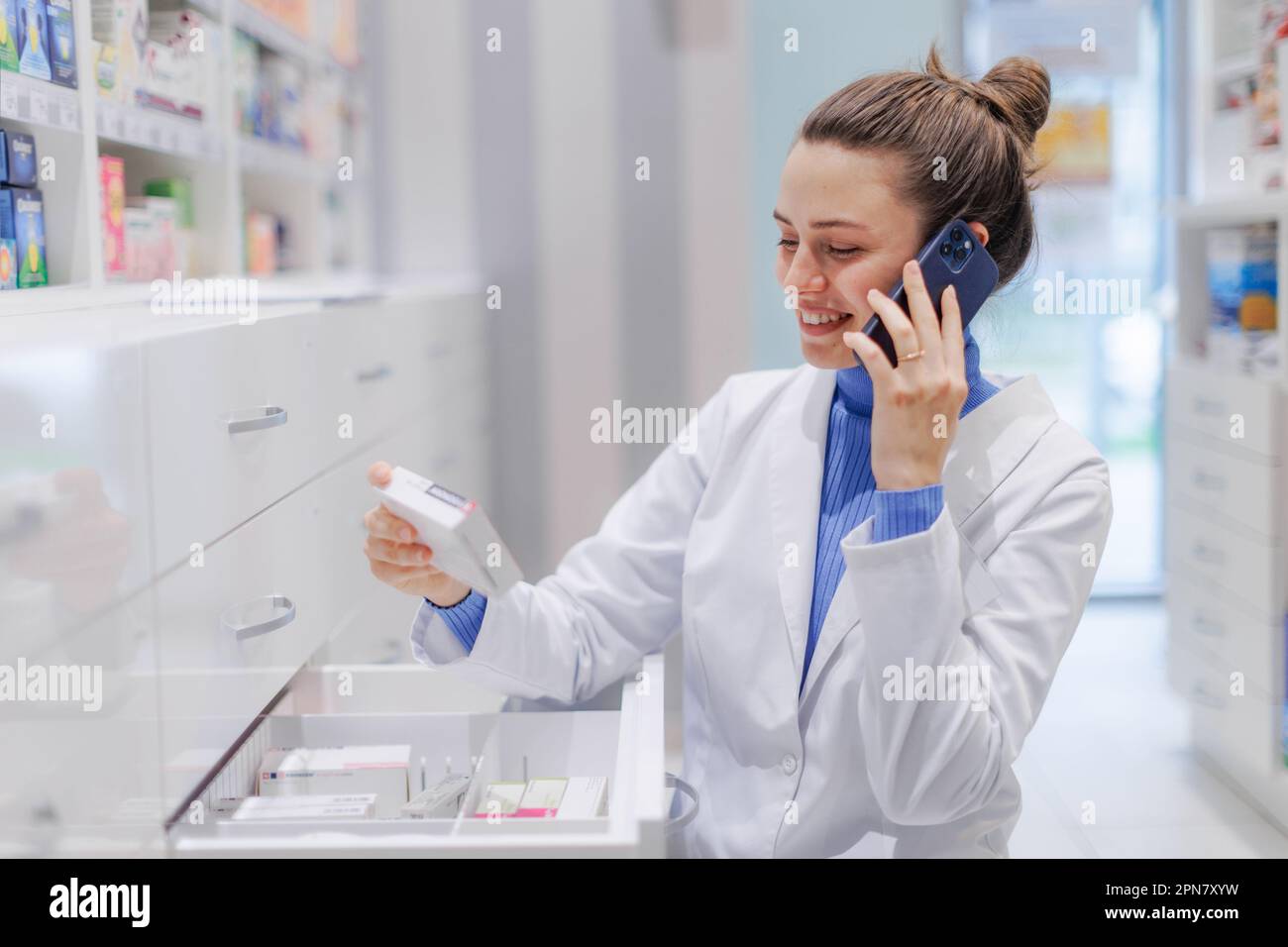 Young pharmacist checking medicine stock in pharmacy Stock Photo - Alamy