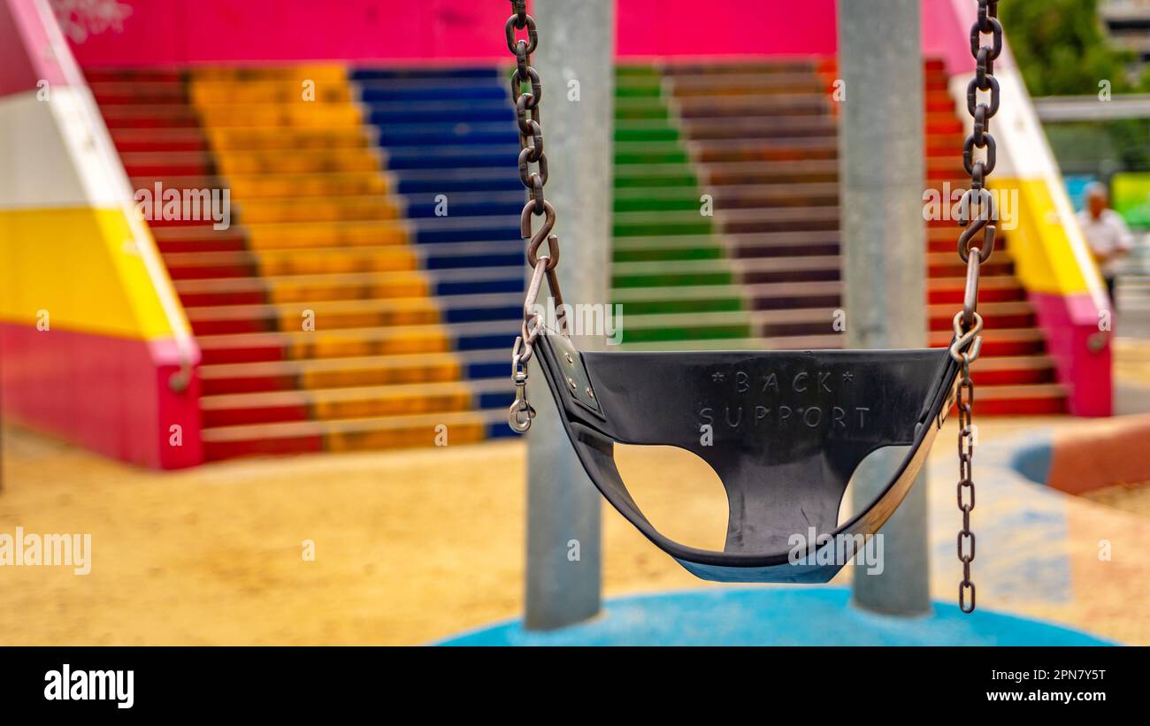 Empty kids playground swing chair Stock Photo - Alamy