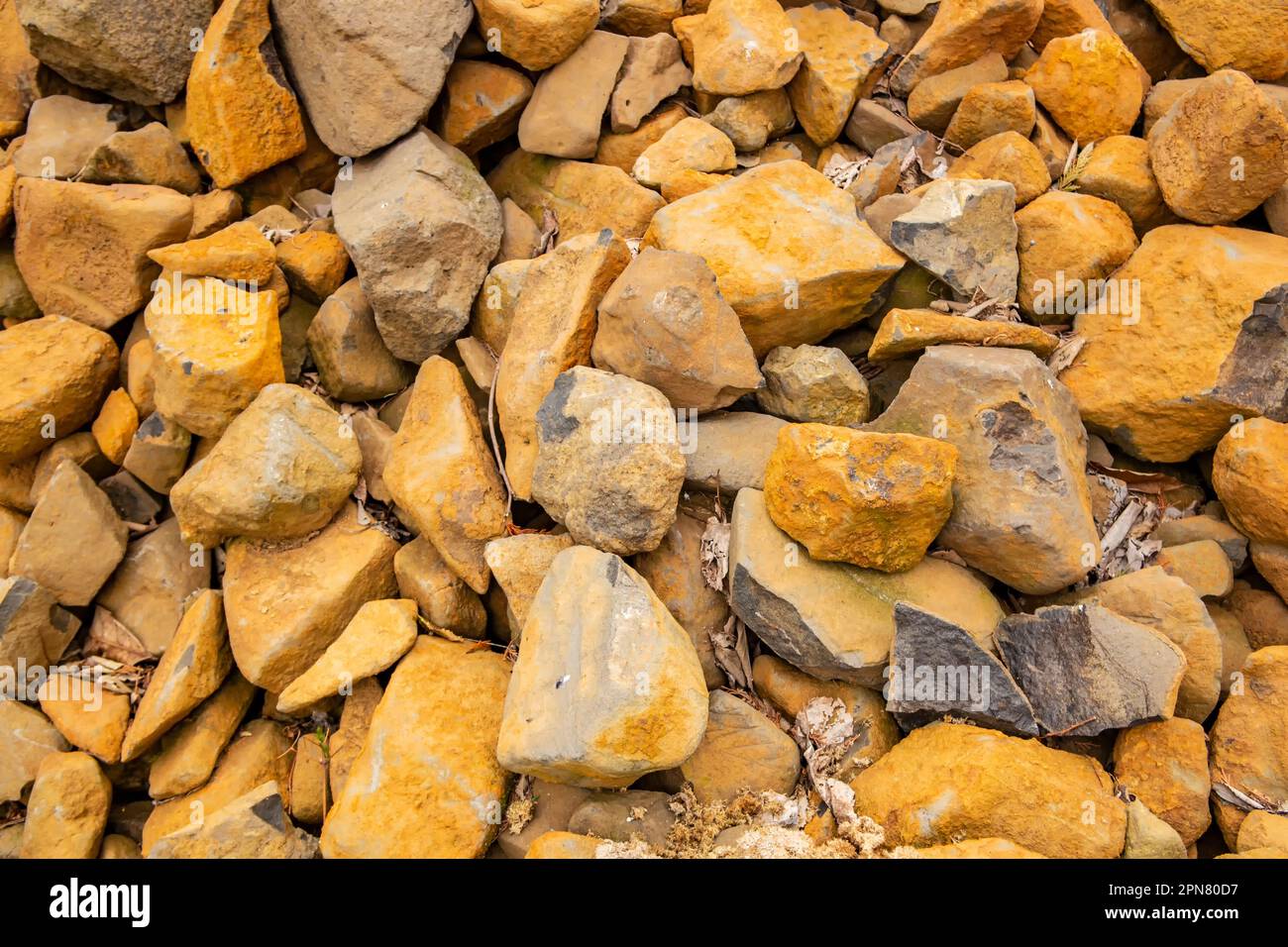 Background with dark stones with yellowish dust Stock Photo - Alamy