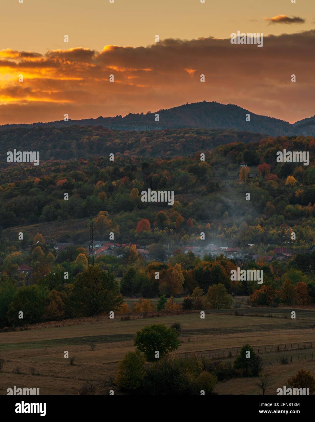 A scenic landscape view of rolling hills with a backdrop of trees in ...