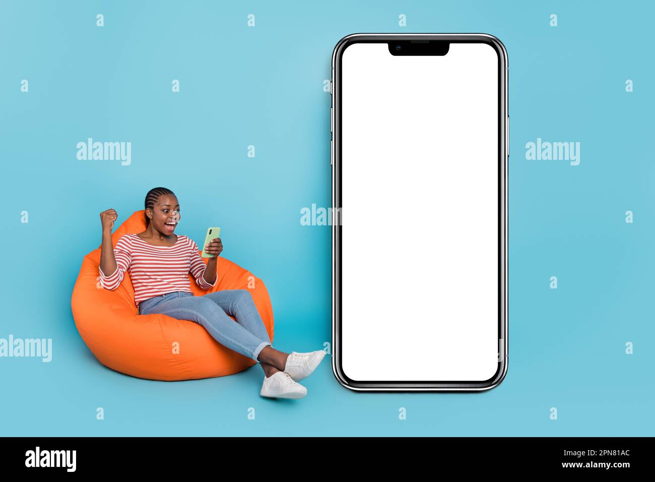 Full body photo of delighted satisfied person sit cozy bag raise fist ...