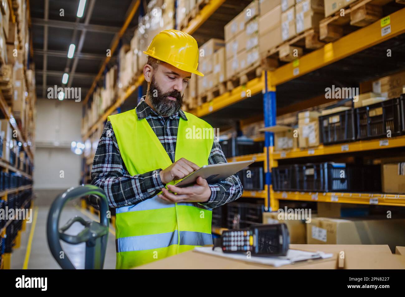 Warehouse worker stocking goods in a warehouse Stock Photo - Alamy