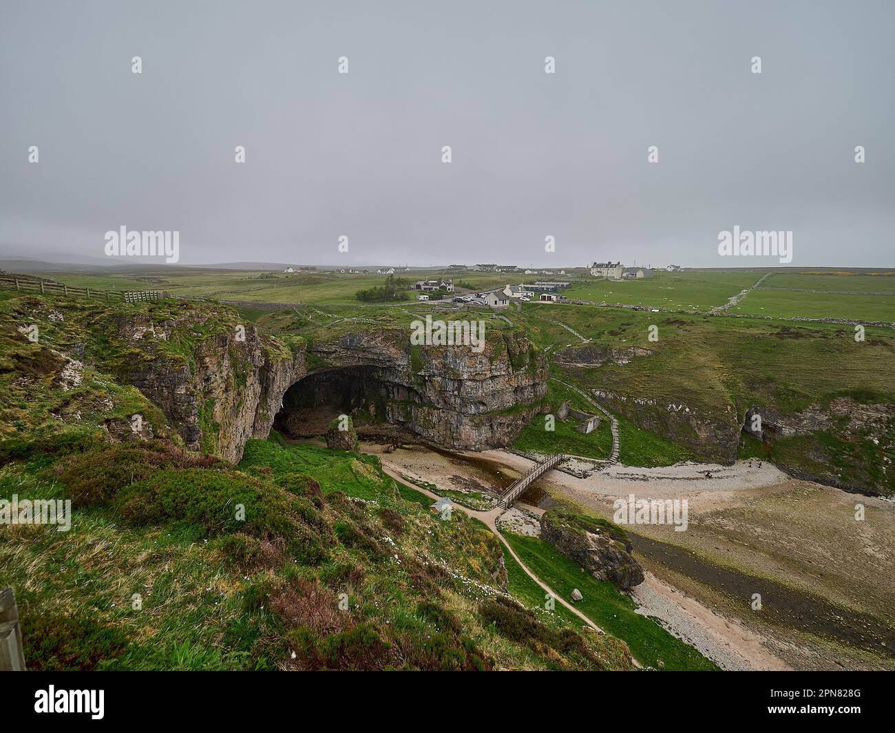 entrance of smoo cave at the coastline of the atlantic ocean in ...