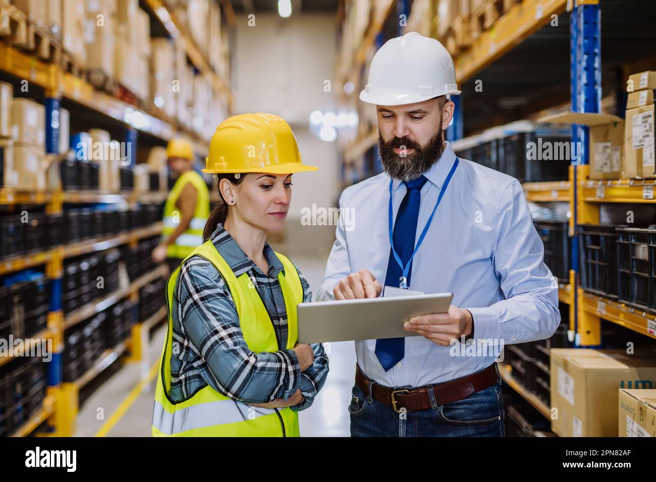 Manager explaining work to his employers in warehouse Stock Photo - Alamy