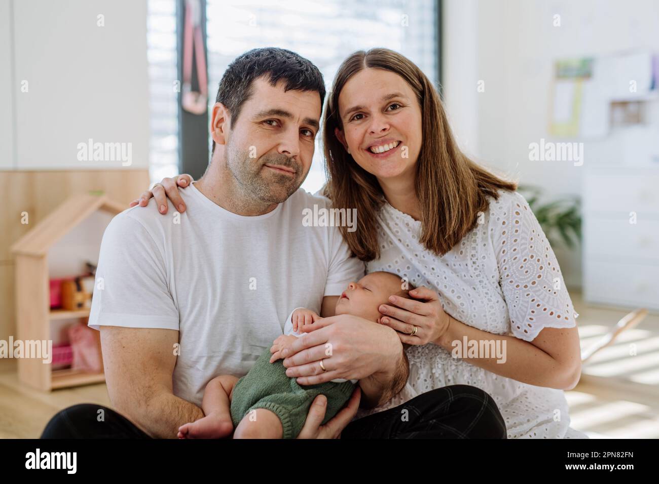 Happy parents cuddling with their newborn baby Stock Photo - Alamy