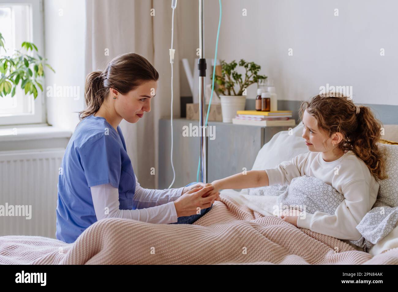 Young nurse taking care of teenage girl Stock Photo - Alamy