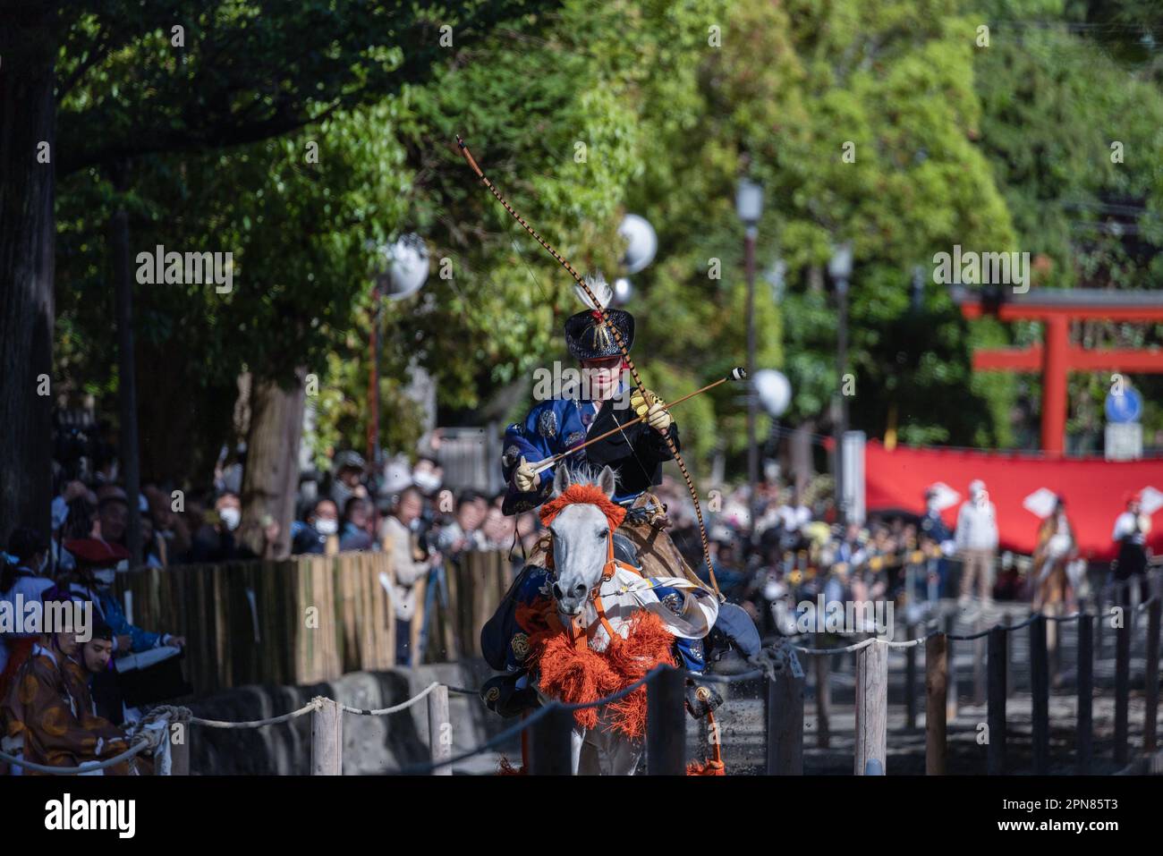 Yabusame (Japanese horseback archery) archer prepares his arrow to ...