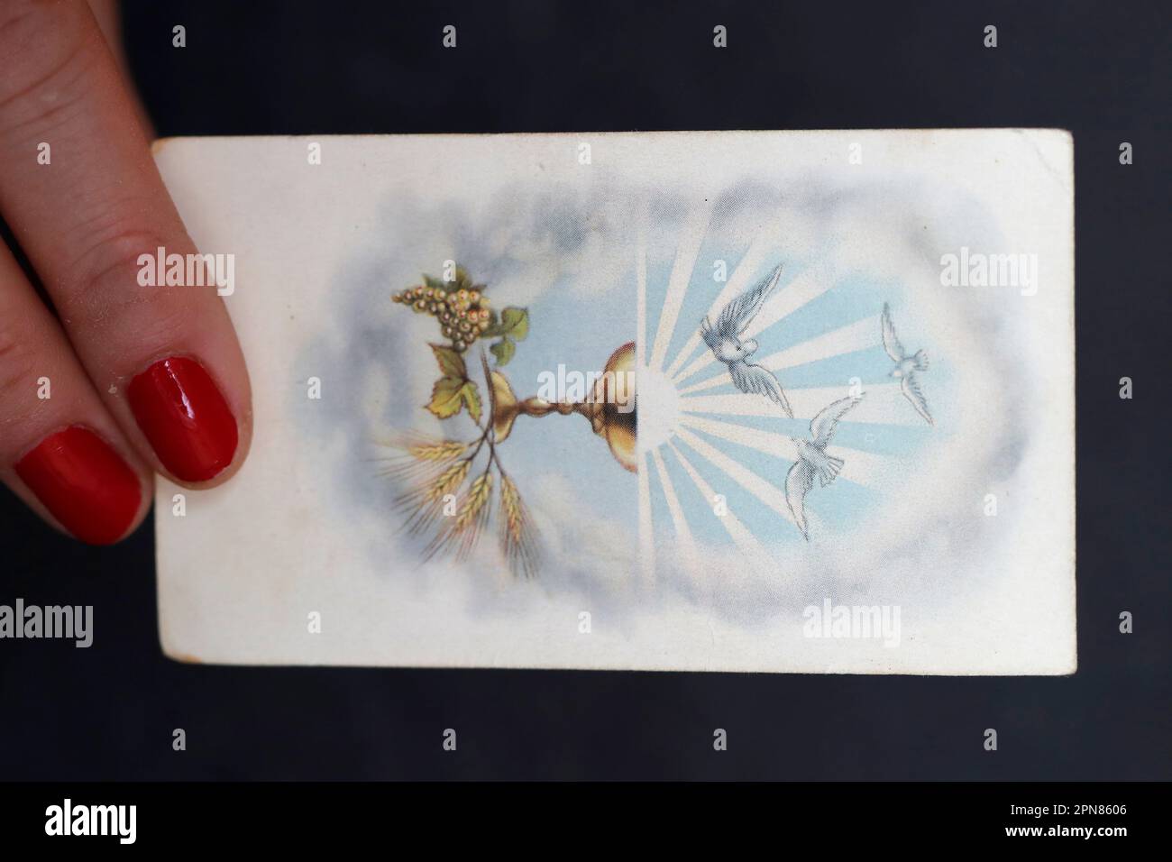 Catholic woman with holy image in hand. Eucharist Stock Photo - Alamy