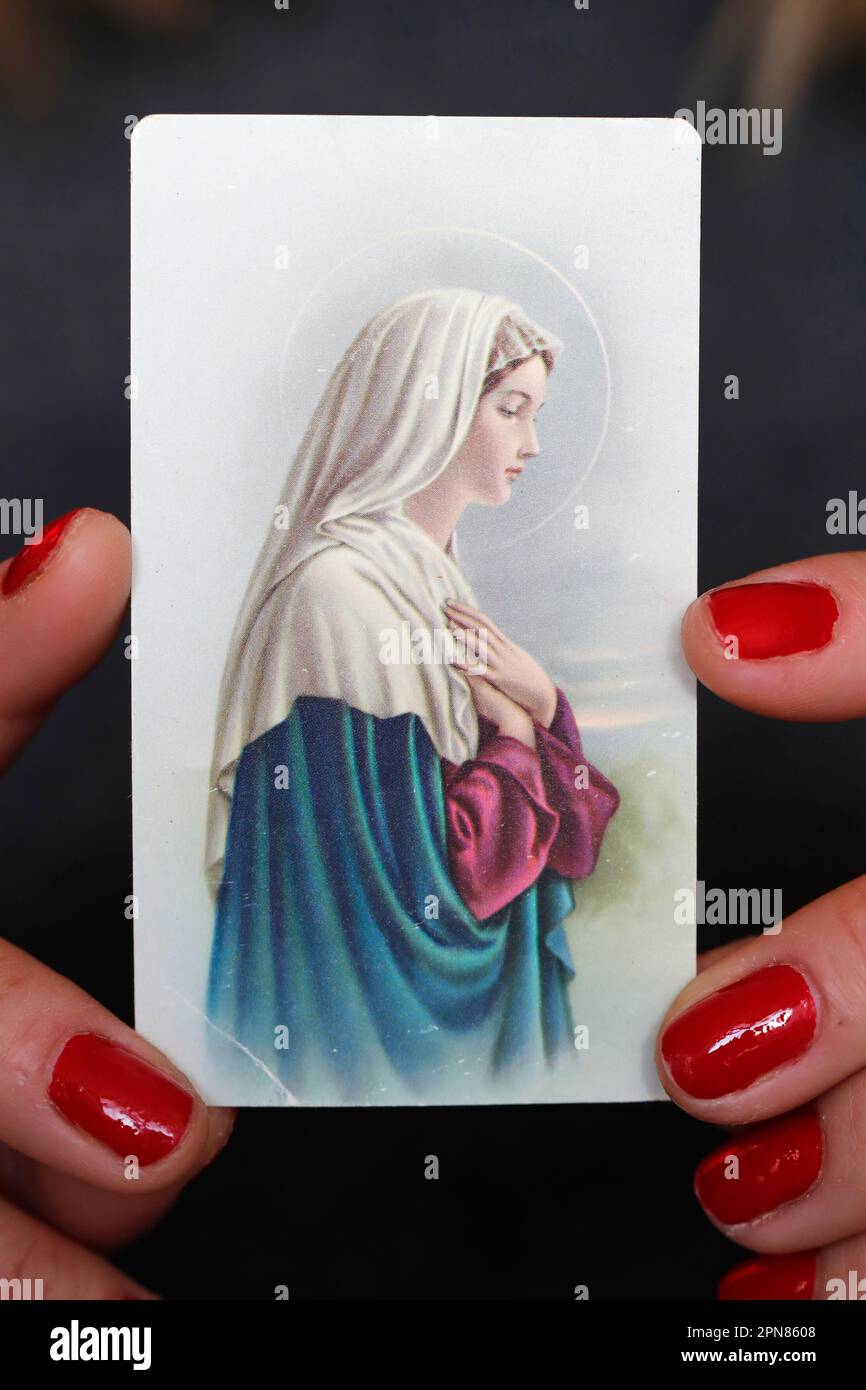 Catholic woman with holy image in hand. Virgin Mary Stock Photo - Alamy