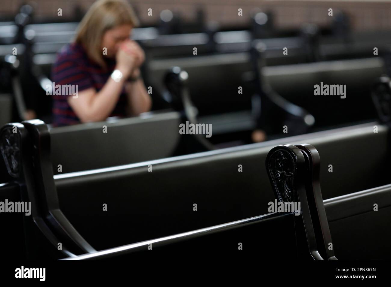 St Joseph's church. Woman praying alone in a church. Singapore Stock ...