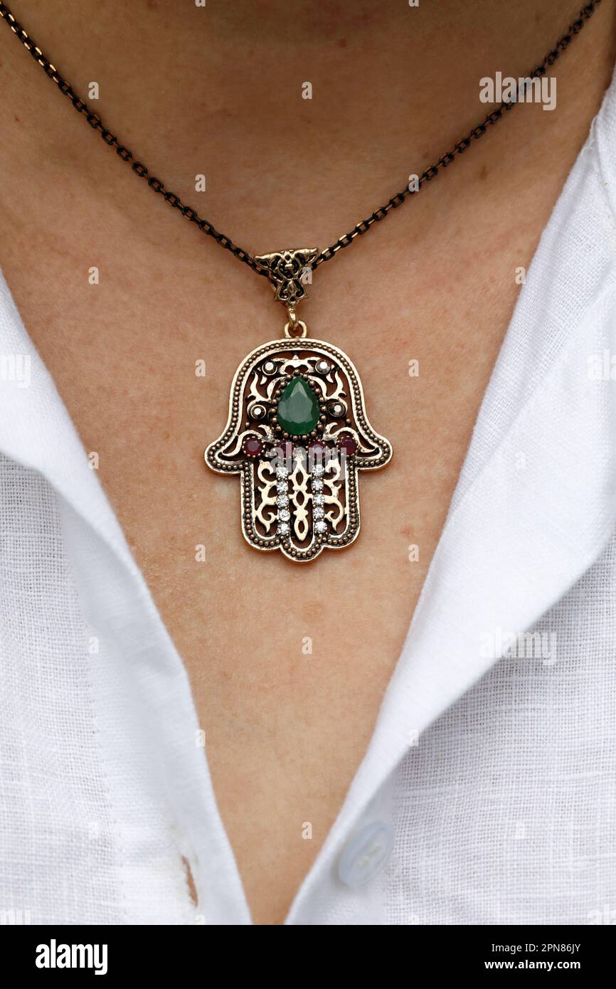Woman wearing a muslim hamsa amulet, also known of the hand of fatima ...