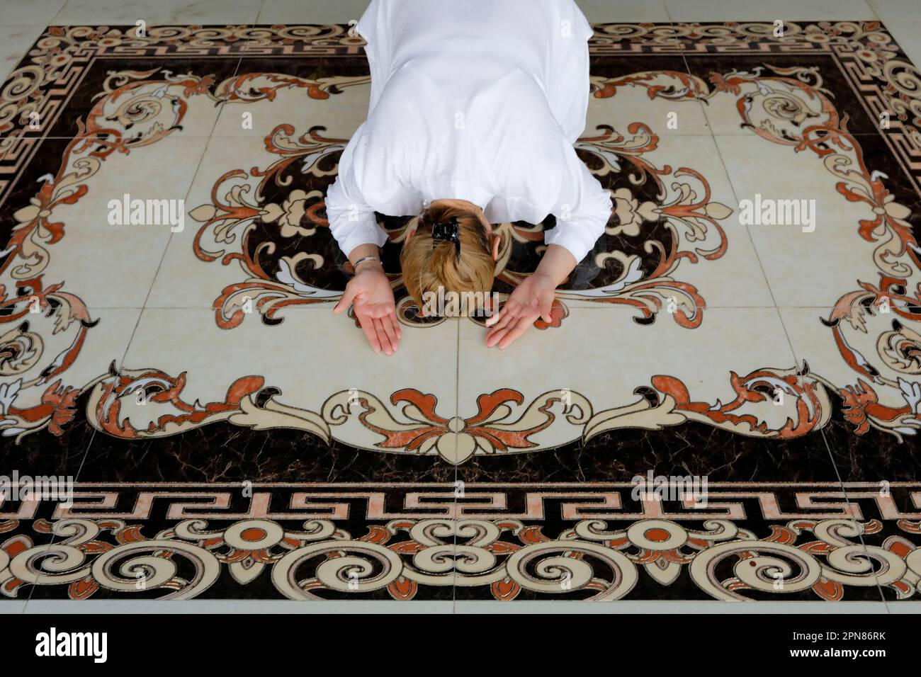 Phat Quang Buddhist temple. Woman worshipper kneeling in prayer and ...