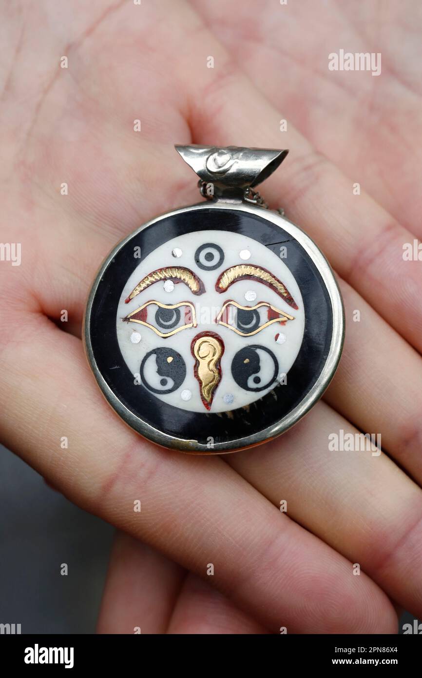 Woman with Tibetan brass and silver eye of buddha mantra pendant ...